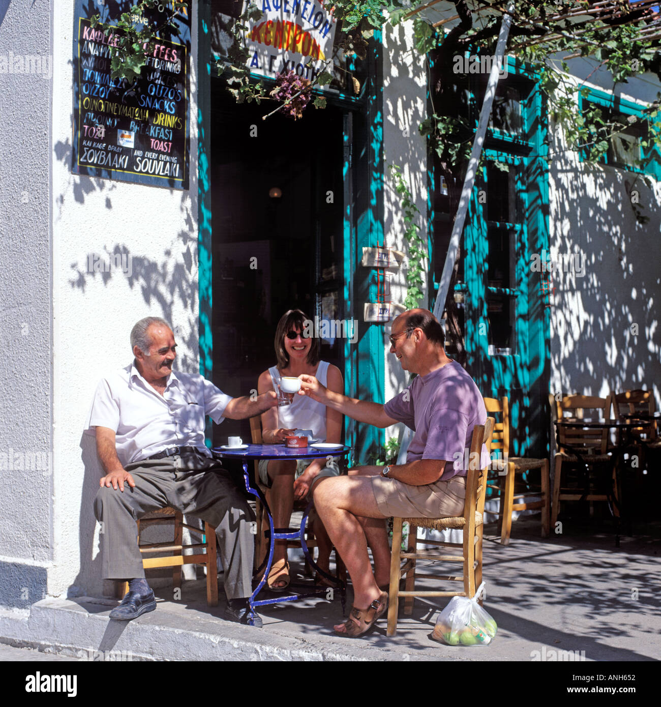 COUPLE AND LOCAL MAN GREECE GENERAL Stock Photo - Alamy