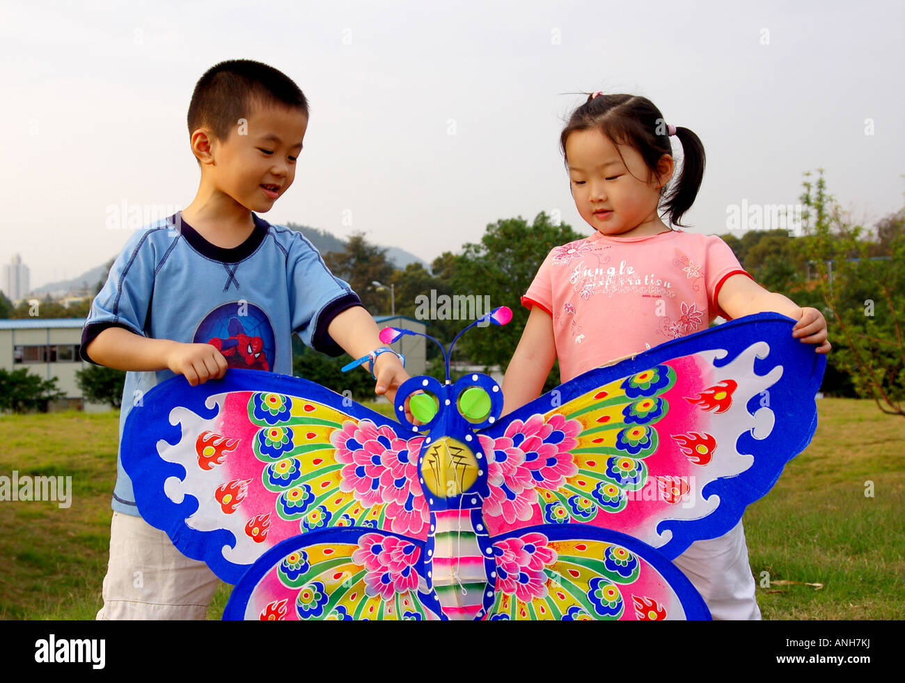 A girl and boy in the park play kite Stock Photo - Alamy
