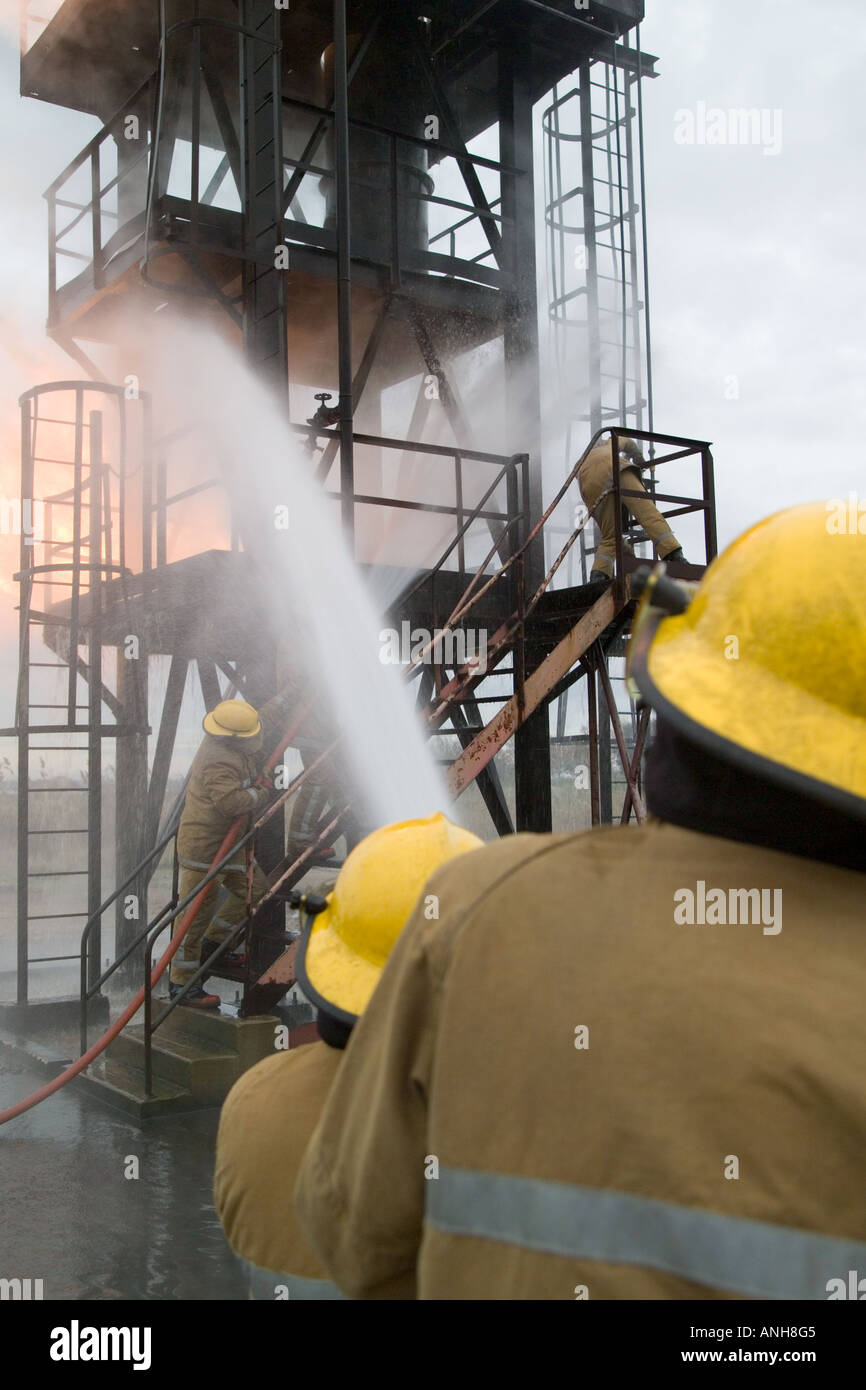 Planned teamwork fire fighting practice Stock Photo - Alamy