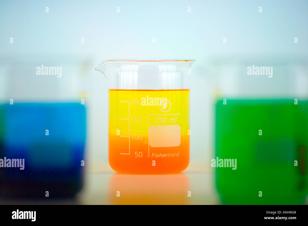 3 three beaker chemical beakers with coloured liquids Stock Photo - Alamy