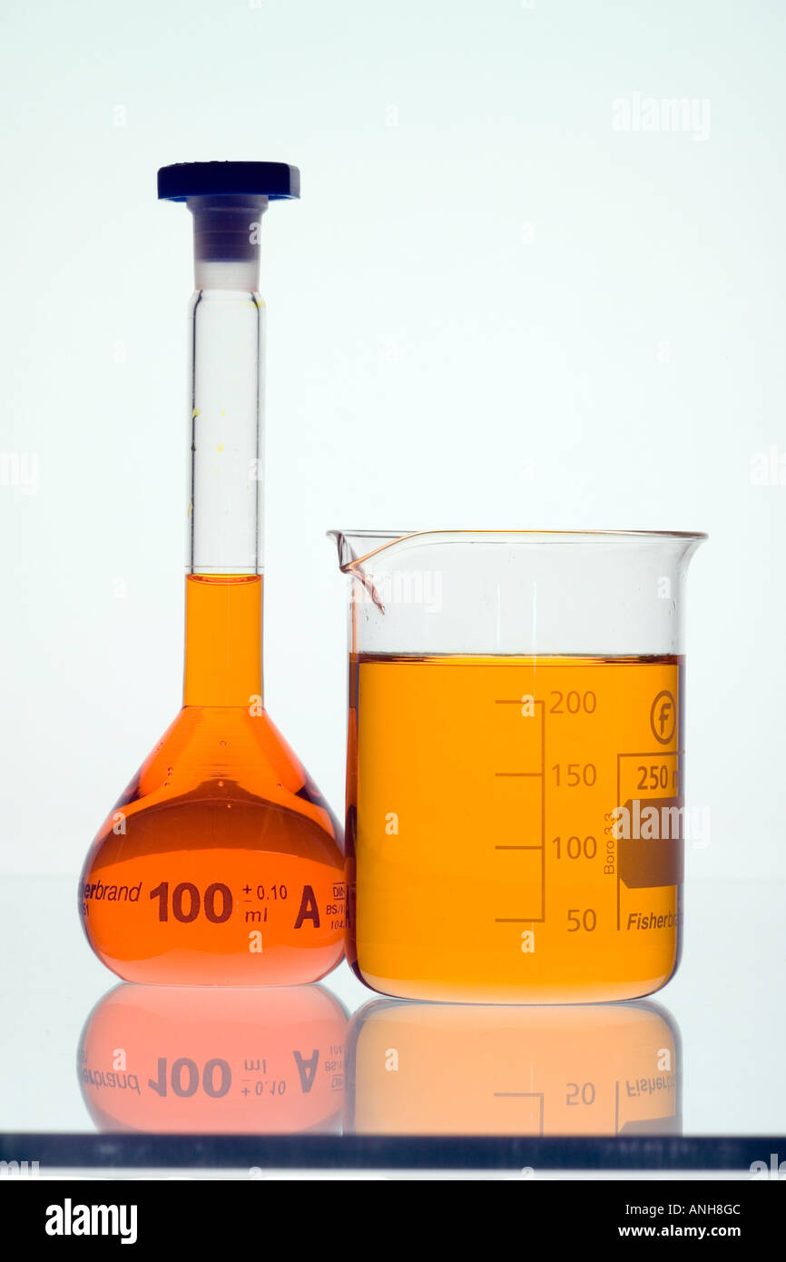 beaker chemical flask with orange liquids Stock Photo - Alamy