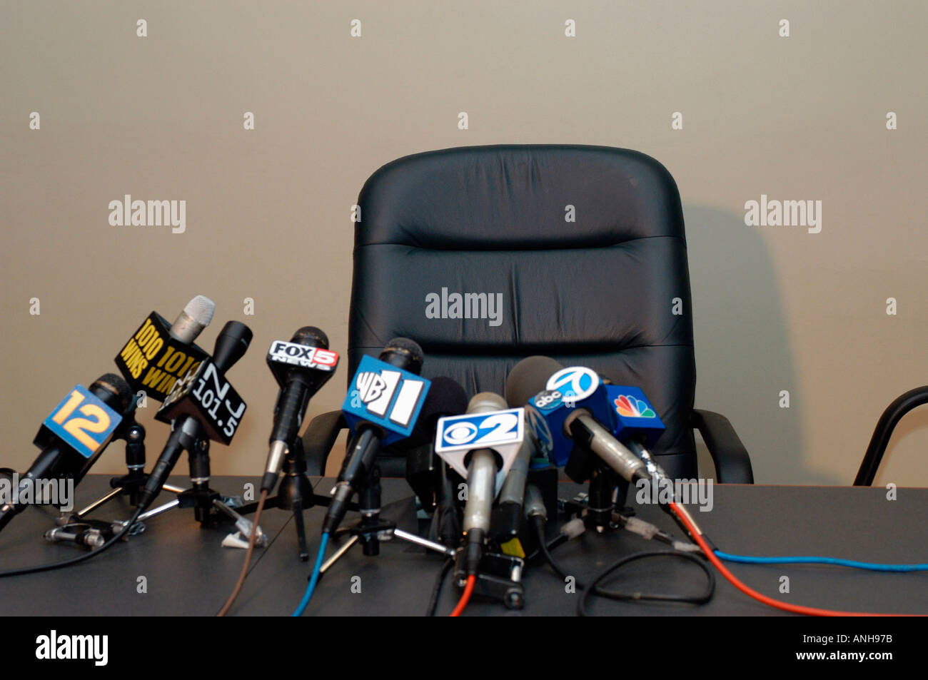 Microphones and empty chair at press conference Stock Photo - Alamy