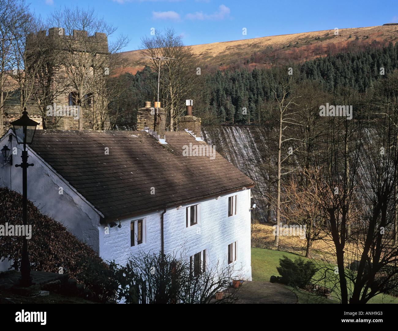 White cottage by Howden Dam with water from Howden Reservoir in Peak ...