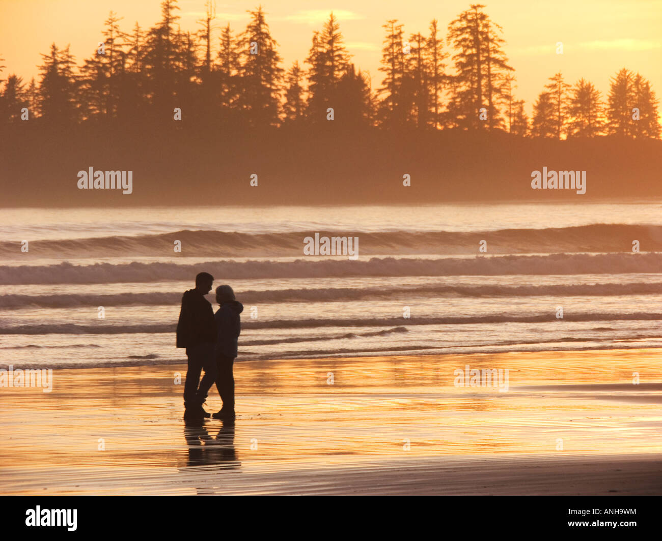 Couple on Long Beach at sunset, Pacific Rim National Park, British ...