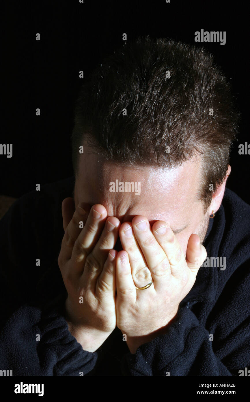 Man with hands covering face Stock Photo - Alamy