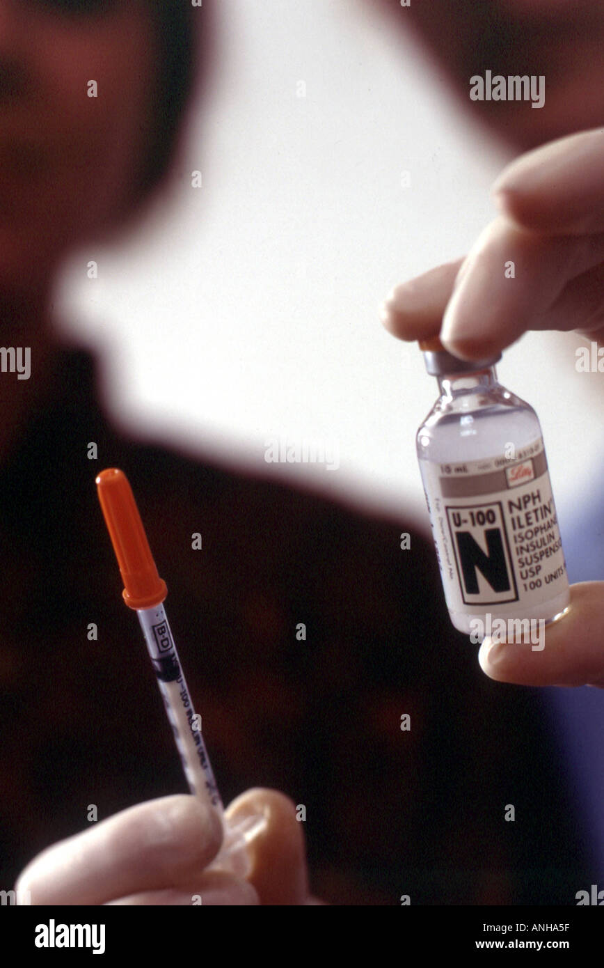 Gloved hands hold insulin bottle ready for injection Patient with ...