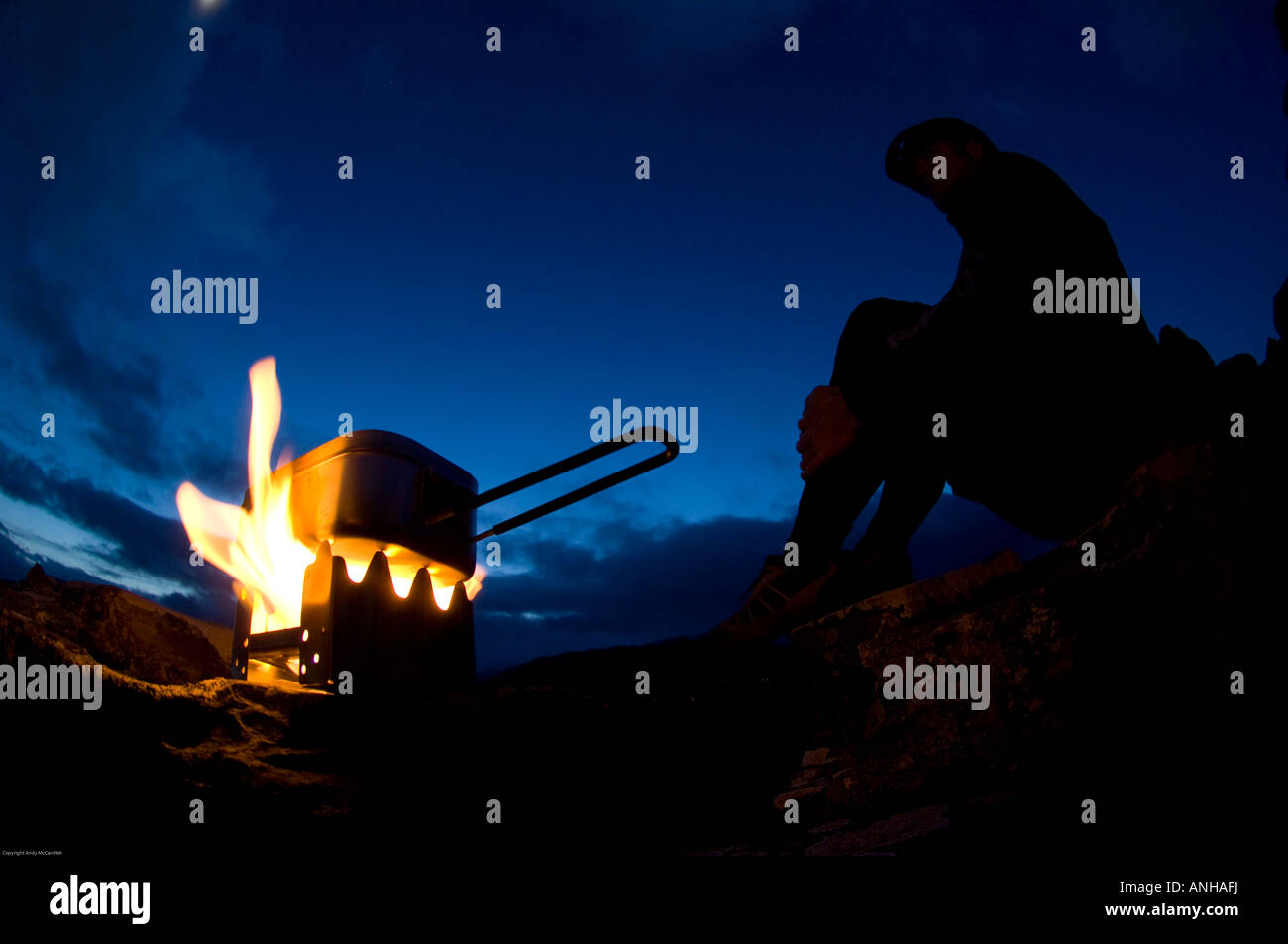 Cooking up a meal under the stars in the Cairngorms, Scotland. Using a ...