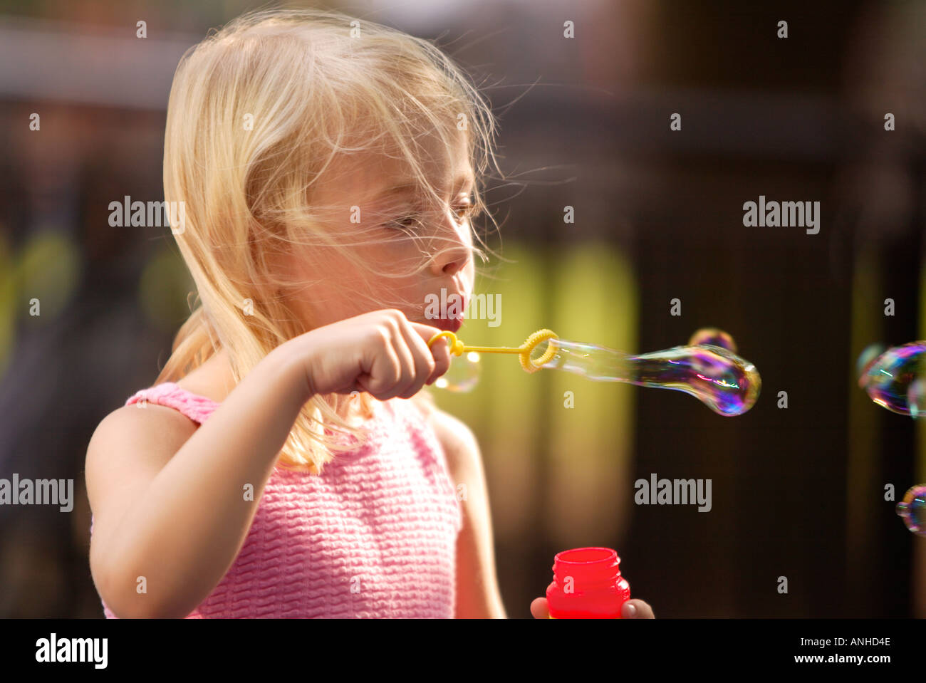 Child blowing bubbles Stock Photo - Alamy