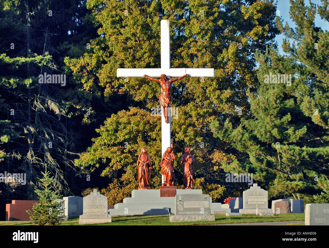Cross with Jesus on display in cemetery Stock Photo - Alamy