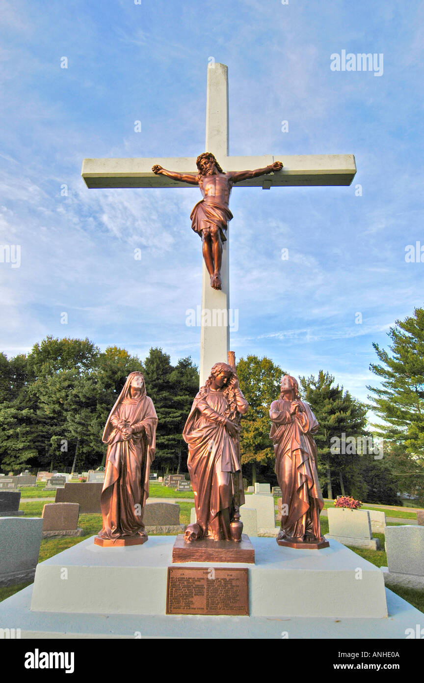 Cross with Jesus on display in cemetery Stock Photo - Alamy