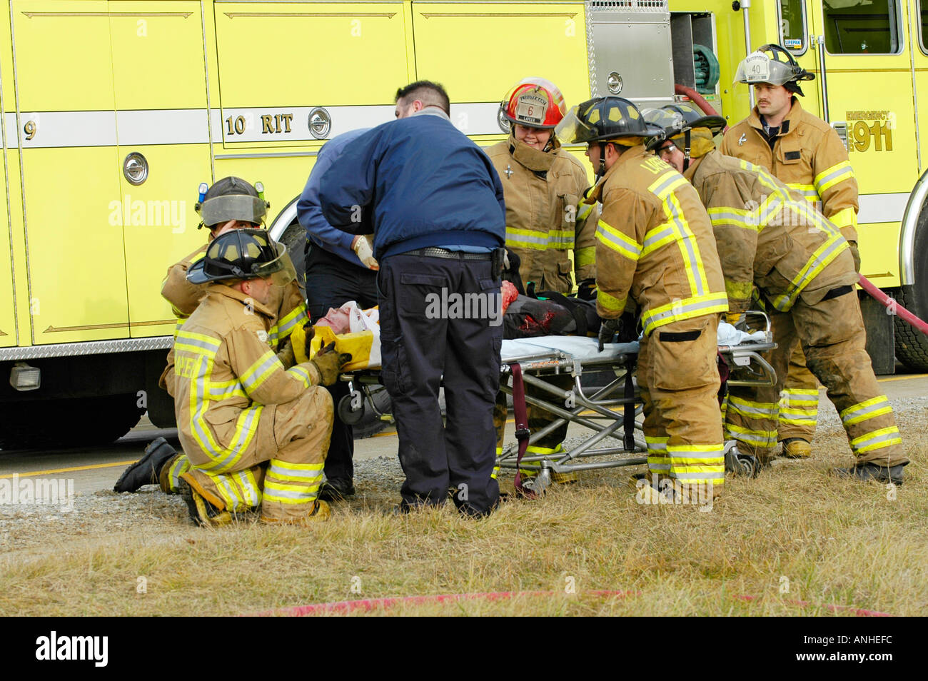 Firemen attend to injured crash victims of a head on automobile crash ...