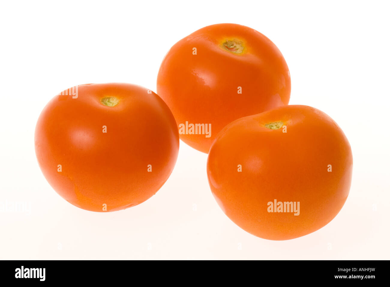 three tomatoes on a white background Stock Photo - Alamy