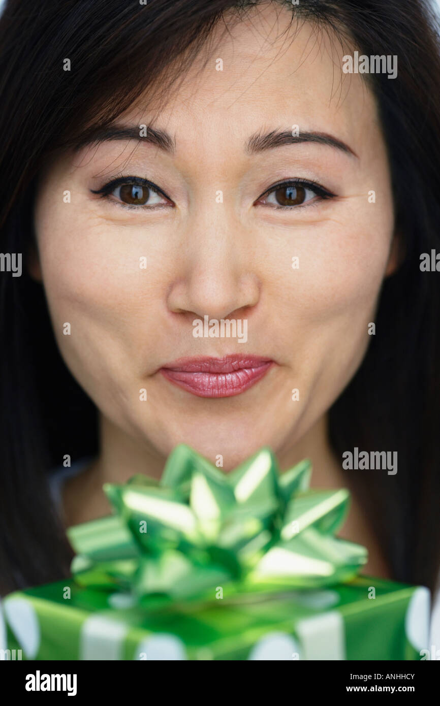 Asian woman holding gift Stock Photo - Alamy