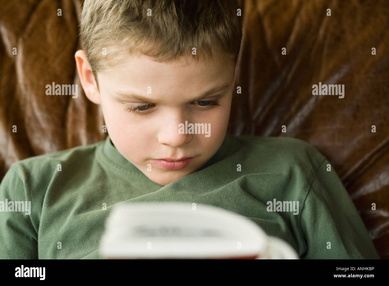 Boy reading, head and shoulders Stock Photo - Alamy