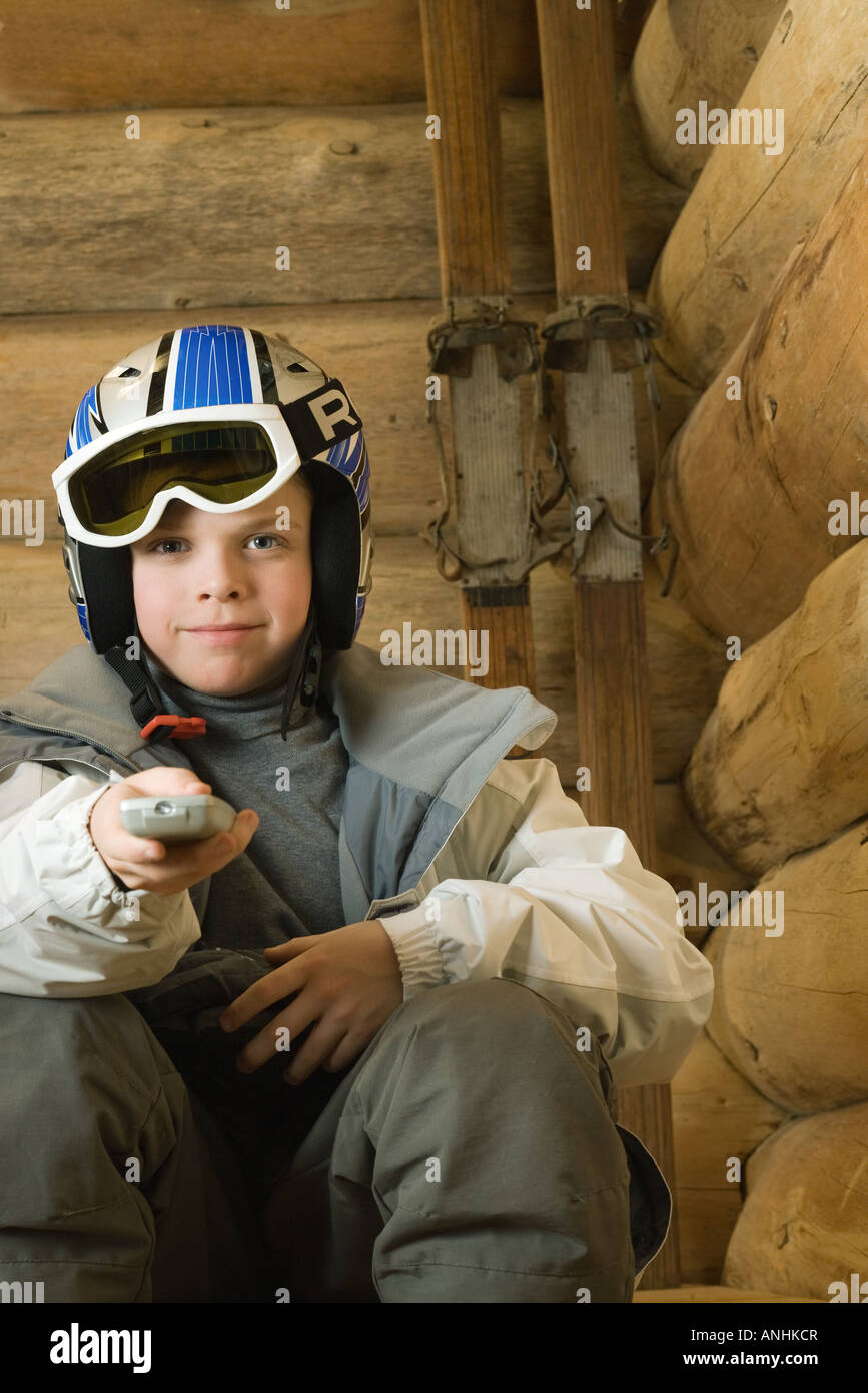 Boy in ski gear pointing remote control at camera Stock Photo - Alamy