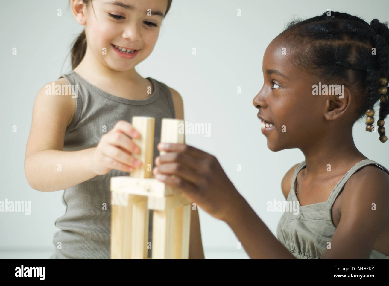 Two girls playing with building blocks together, both smiling Stock ...