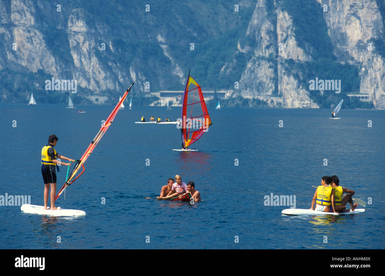 Sail boarders learn sailboarding in front of Torbole Garda Lake Italy ...