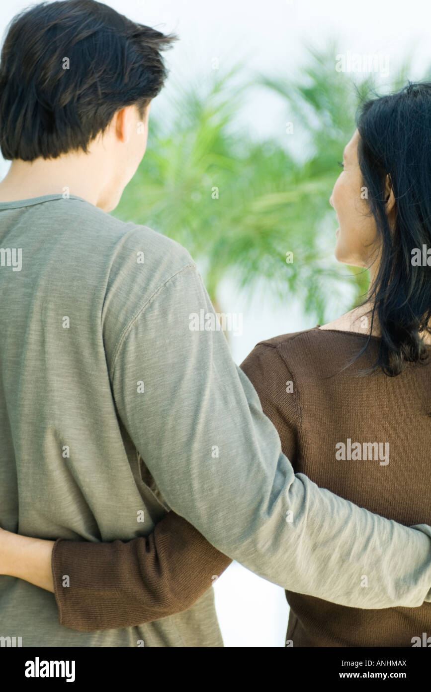 Couple standing with arms around each other, rear view Stock Photo - Alamy