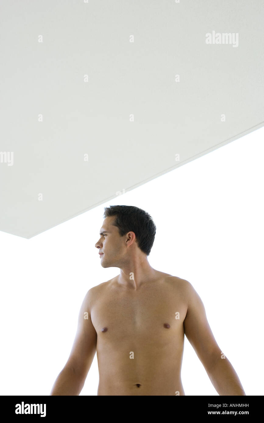 Barechested man looking away, backlit Stock Photo - Alamy
