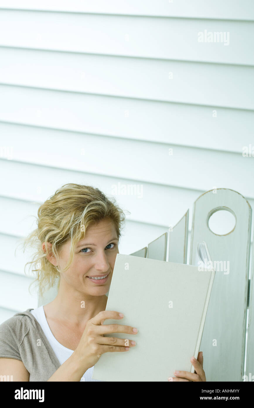 Woman sitting, reading book Stock Photo - Alamy