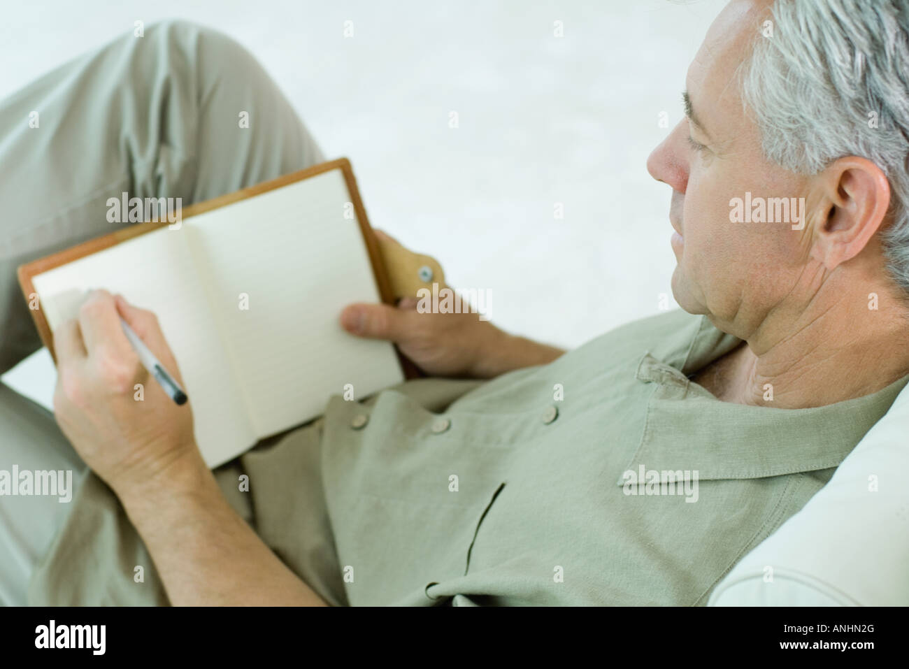 Mature man writing in diary Stock Photo - Alamy