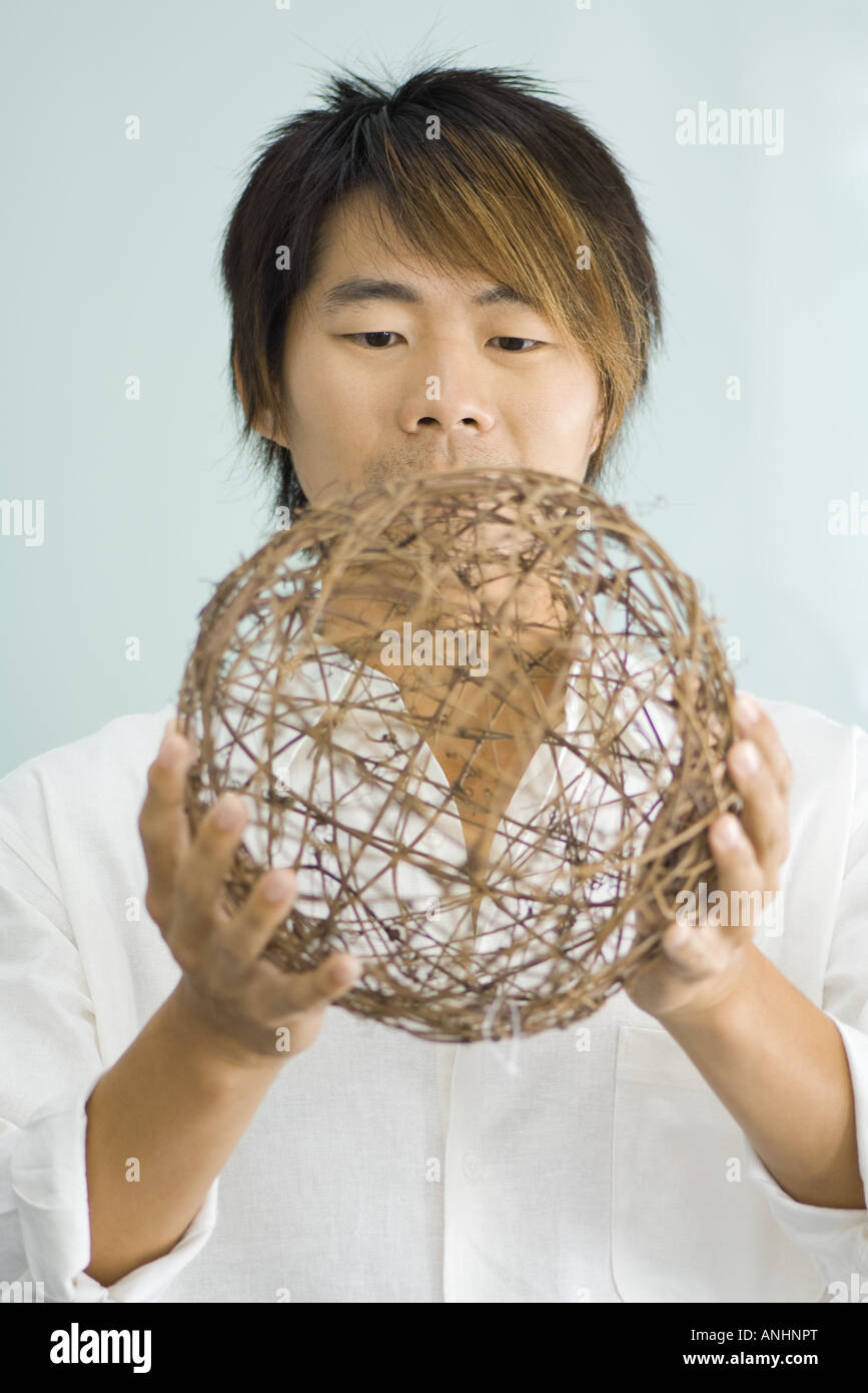 Man holding up sphere Stock Photo - Alamy