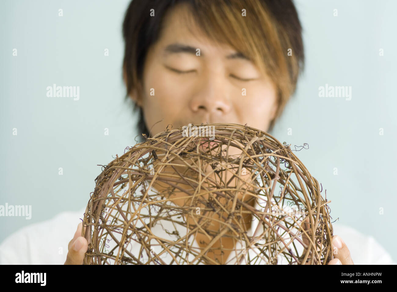 Man holding sphere, eyes closed Stock Photo - Alamy