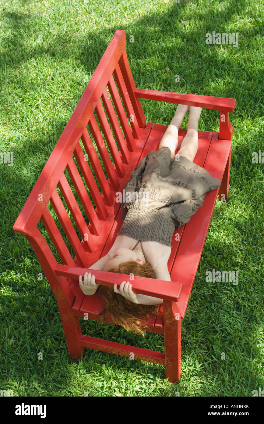 Little girl napping on bench Stock Photo - Alamy