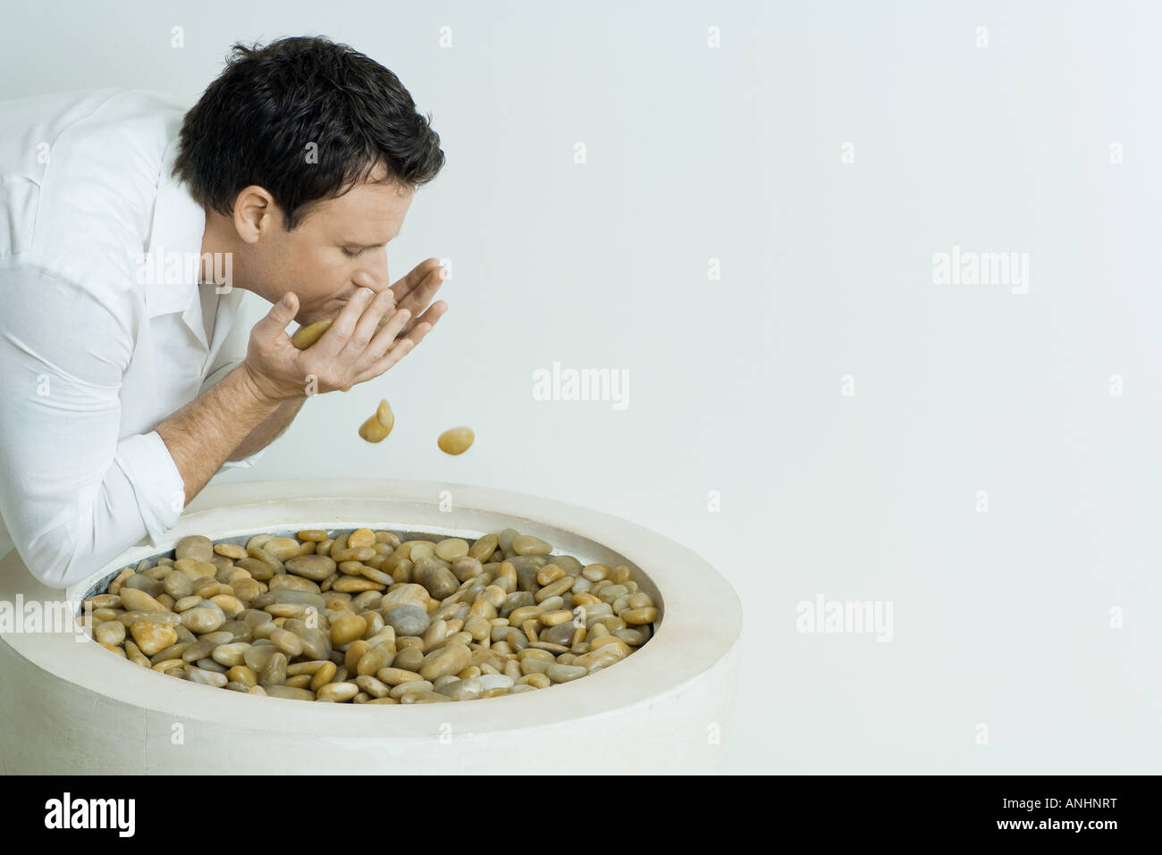 Man splashing face with rocks Stock Photo - Alamy
