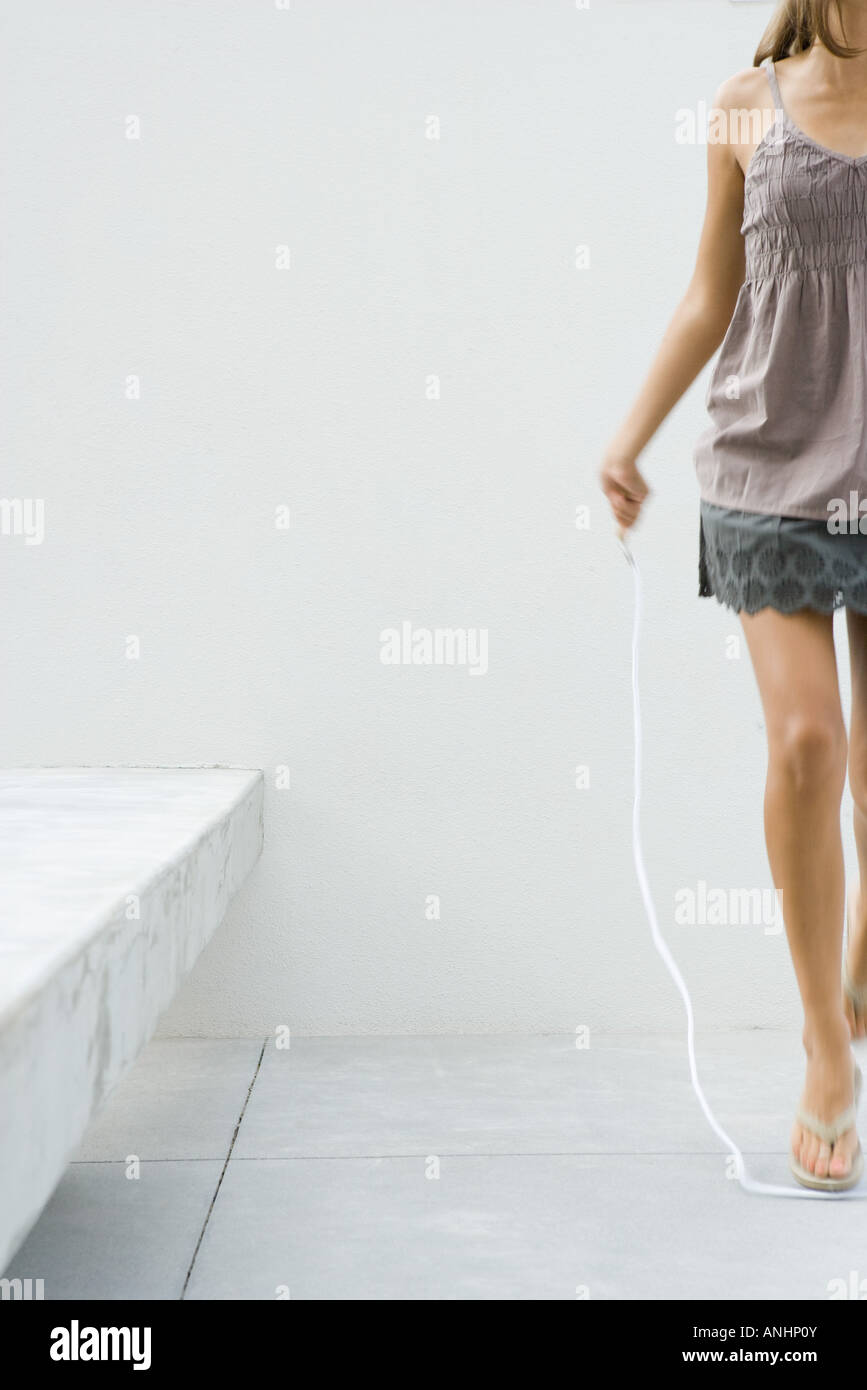 Teenage girl jumping rope, cropped view Stock Photo - Alamy