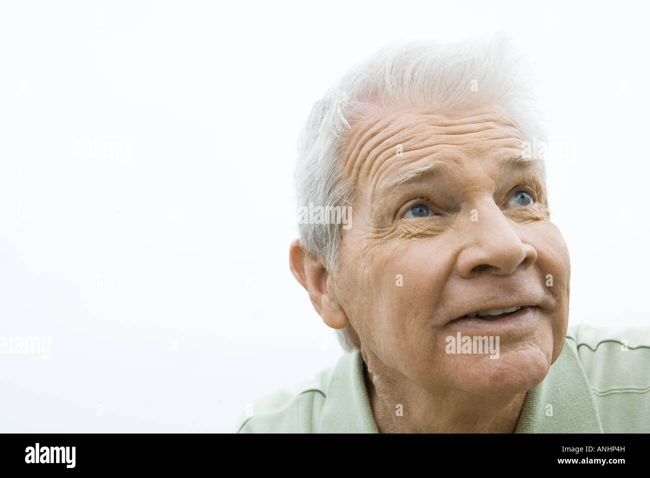 Senior man looking up, smiling, portrait Stock Photo - Alamy