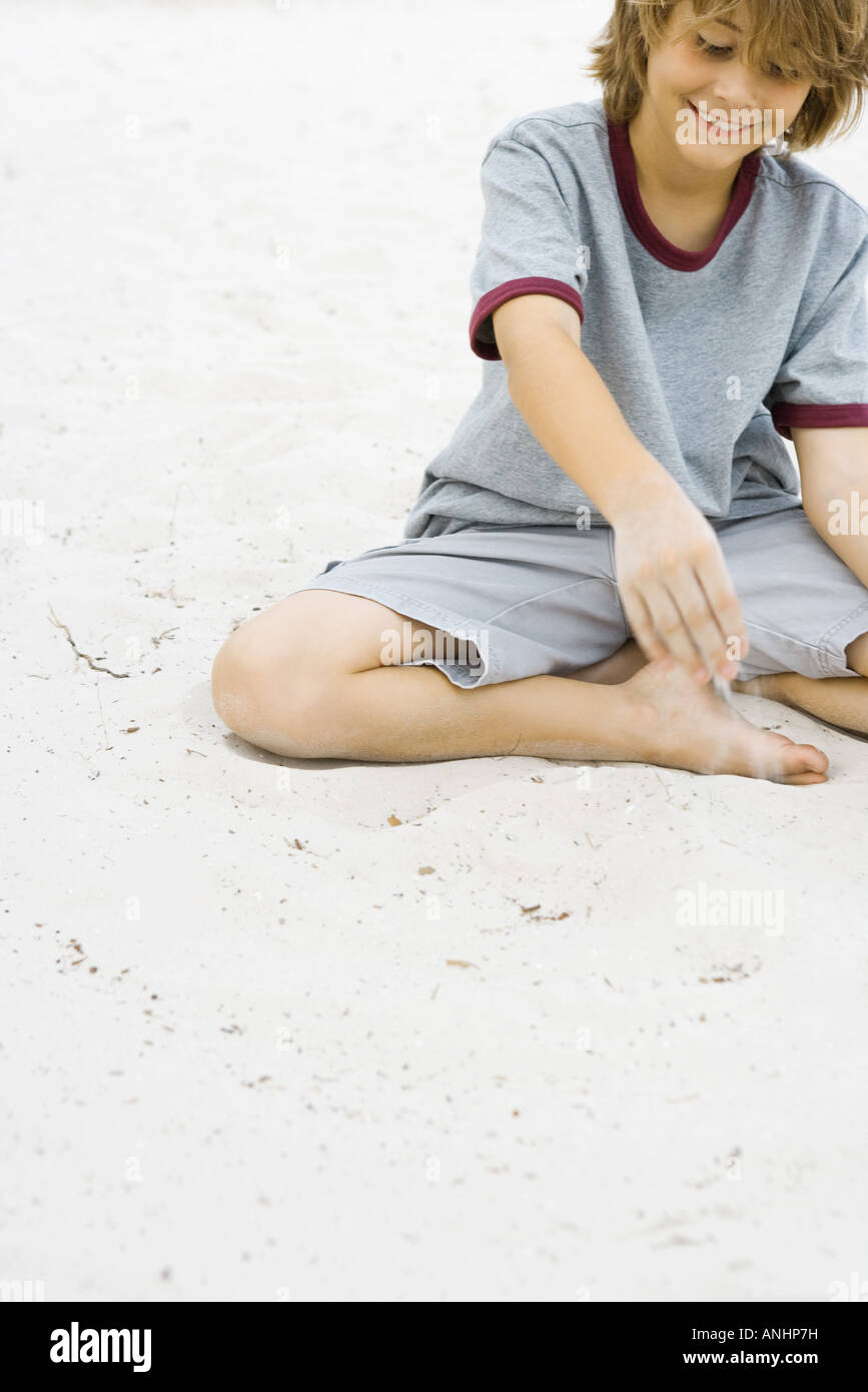 Boy playing in sand, smiling, cropped view Stock Photo - Alamy