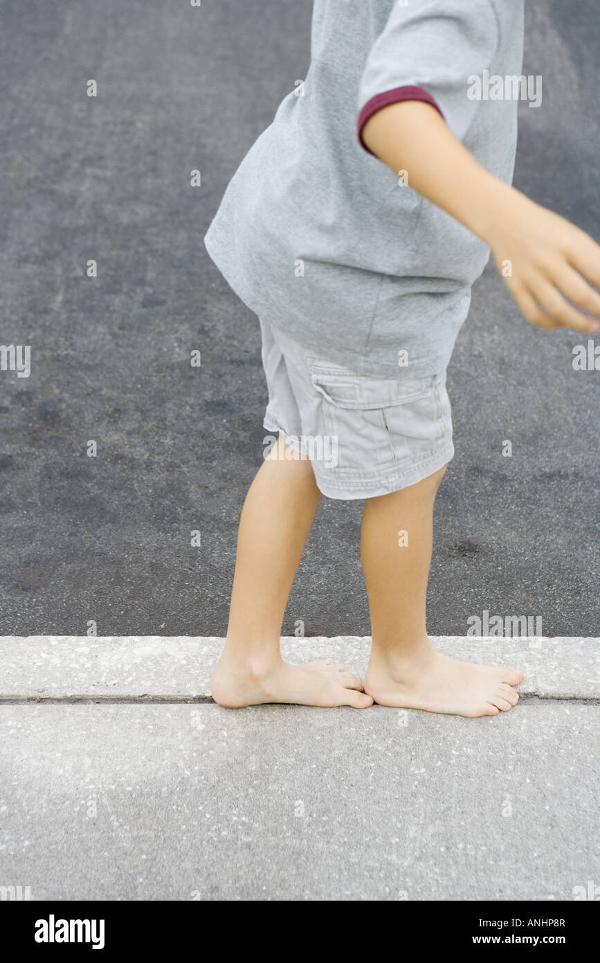 Child walking along crack in sidewalk, cropped view Stock Photo - Alamy