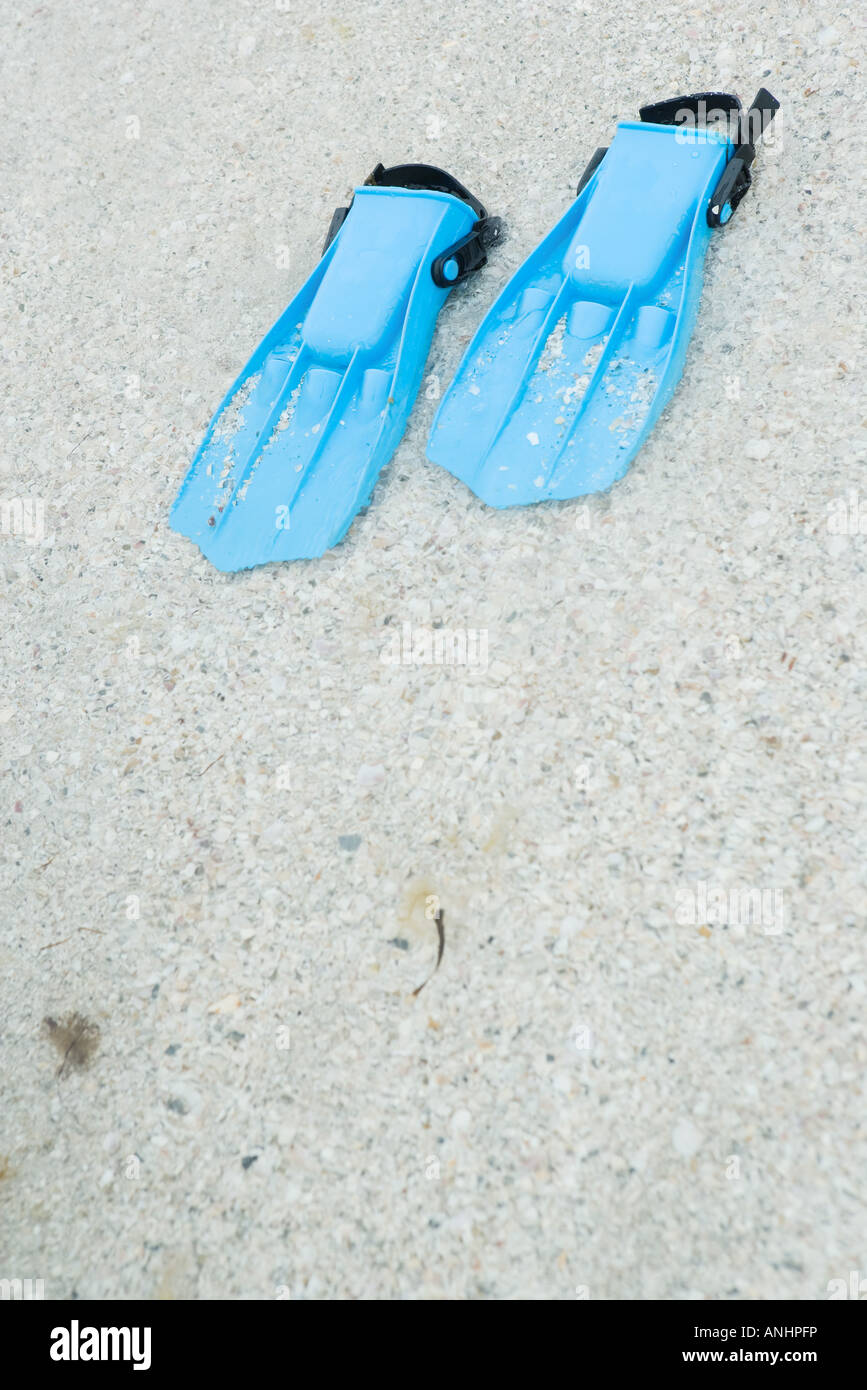 Plastic flippers on sand, close-up Stock Photo - Alamy