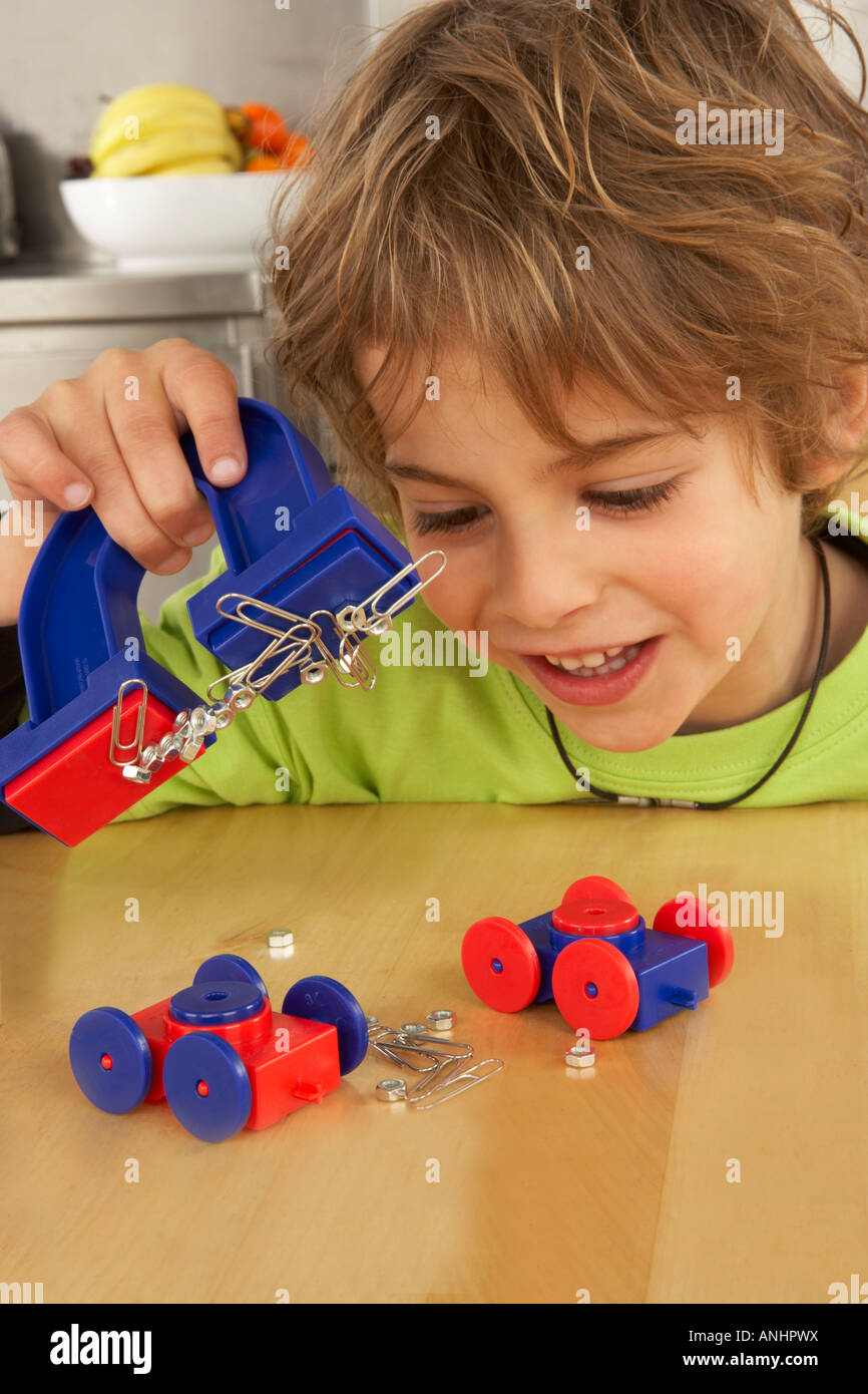 a boy plays with a giant magnet Stock Photo - Alamy