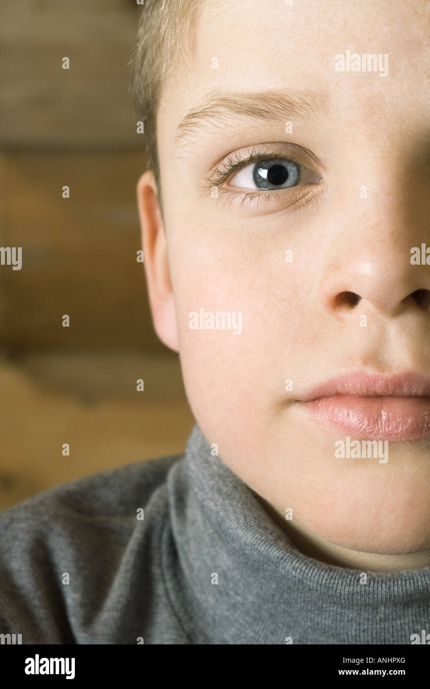 Boy's face, looking at camera, cropped view Stock Photo - Alamy