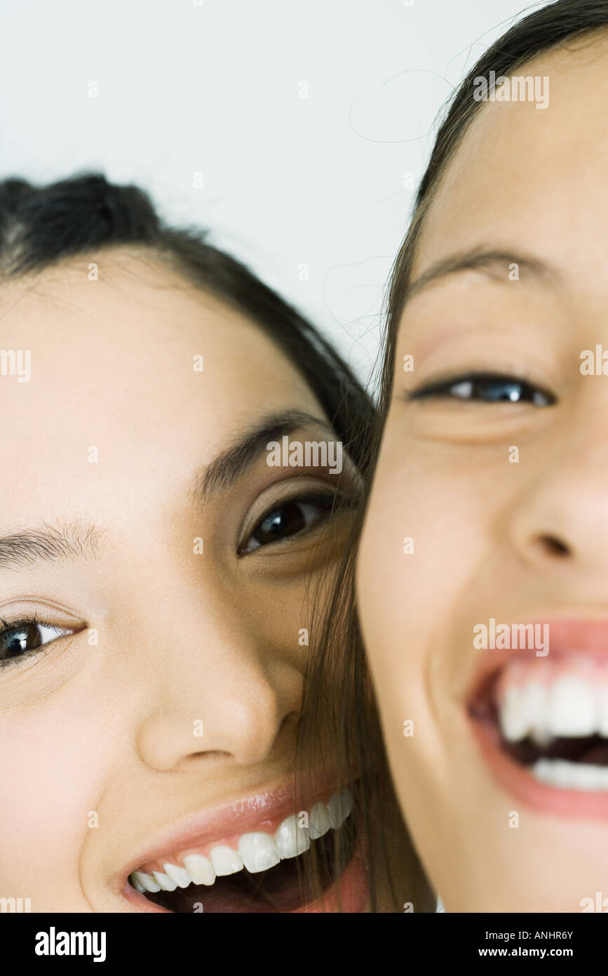 Two young friends smiling at camera, cropped view, close-up Stock Photo ...