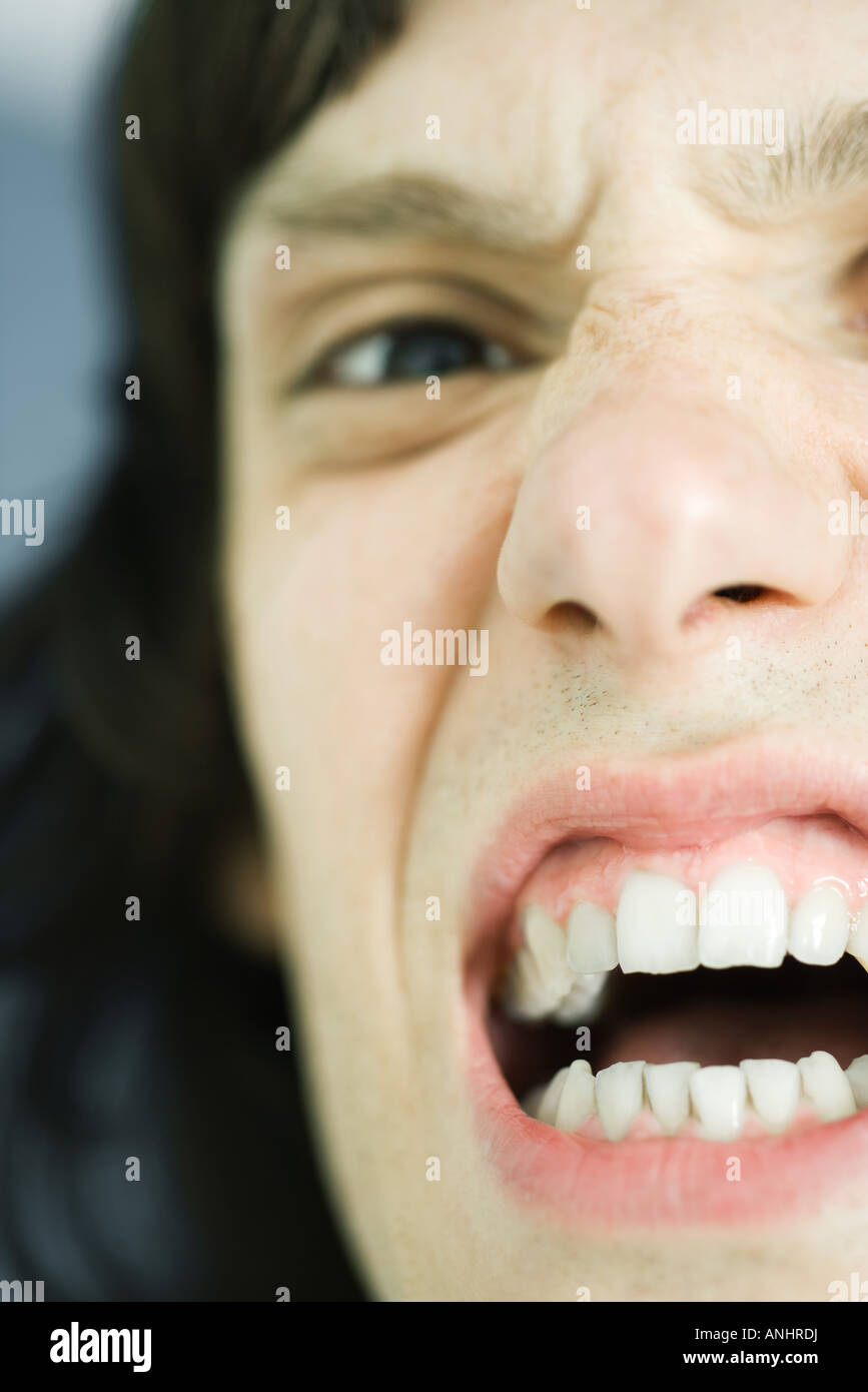 Teenage boy baring teeth, looking at camera, extreme close-up Stock ...