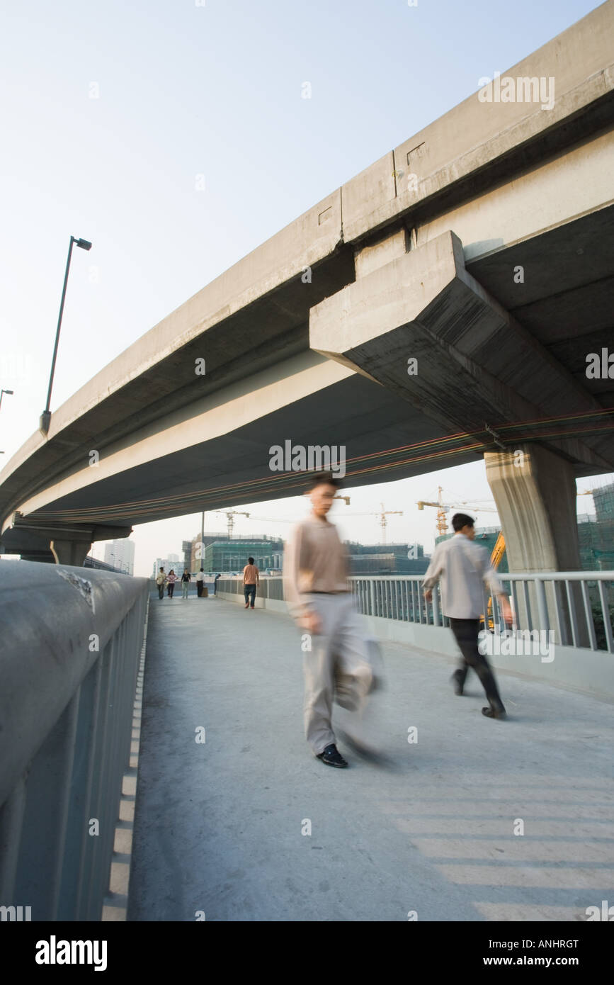 Pedestrians on footbridge under overpass Stock Photo - Alamy