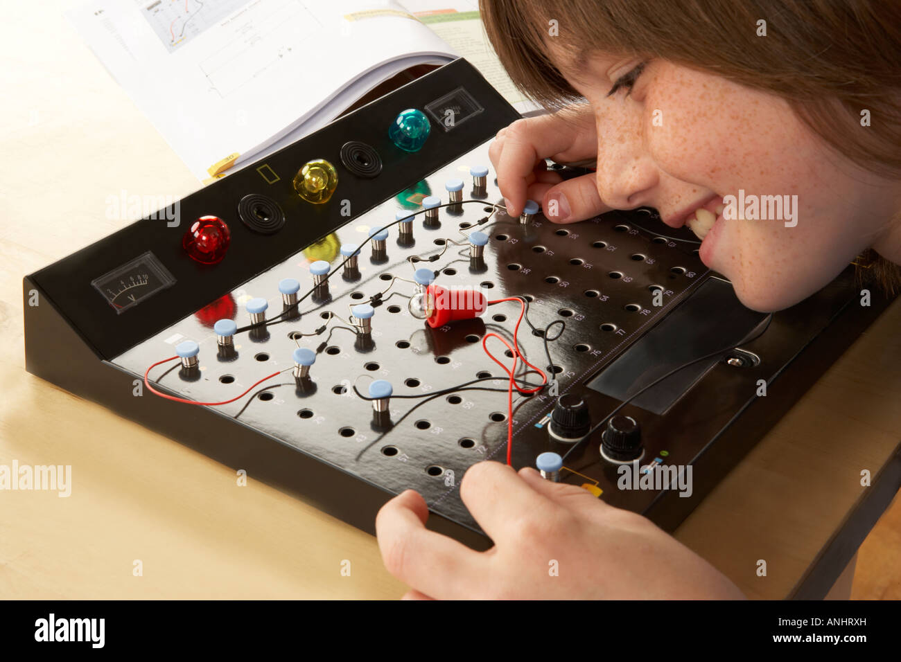 a boy smiles as he plays with an electronics lab Stock Photo - Alamy