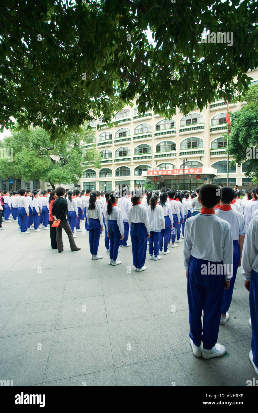 Large group of students in uniform standing in square, rear view Stock ...