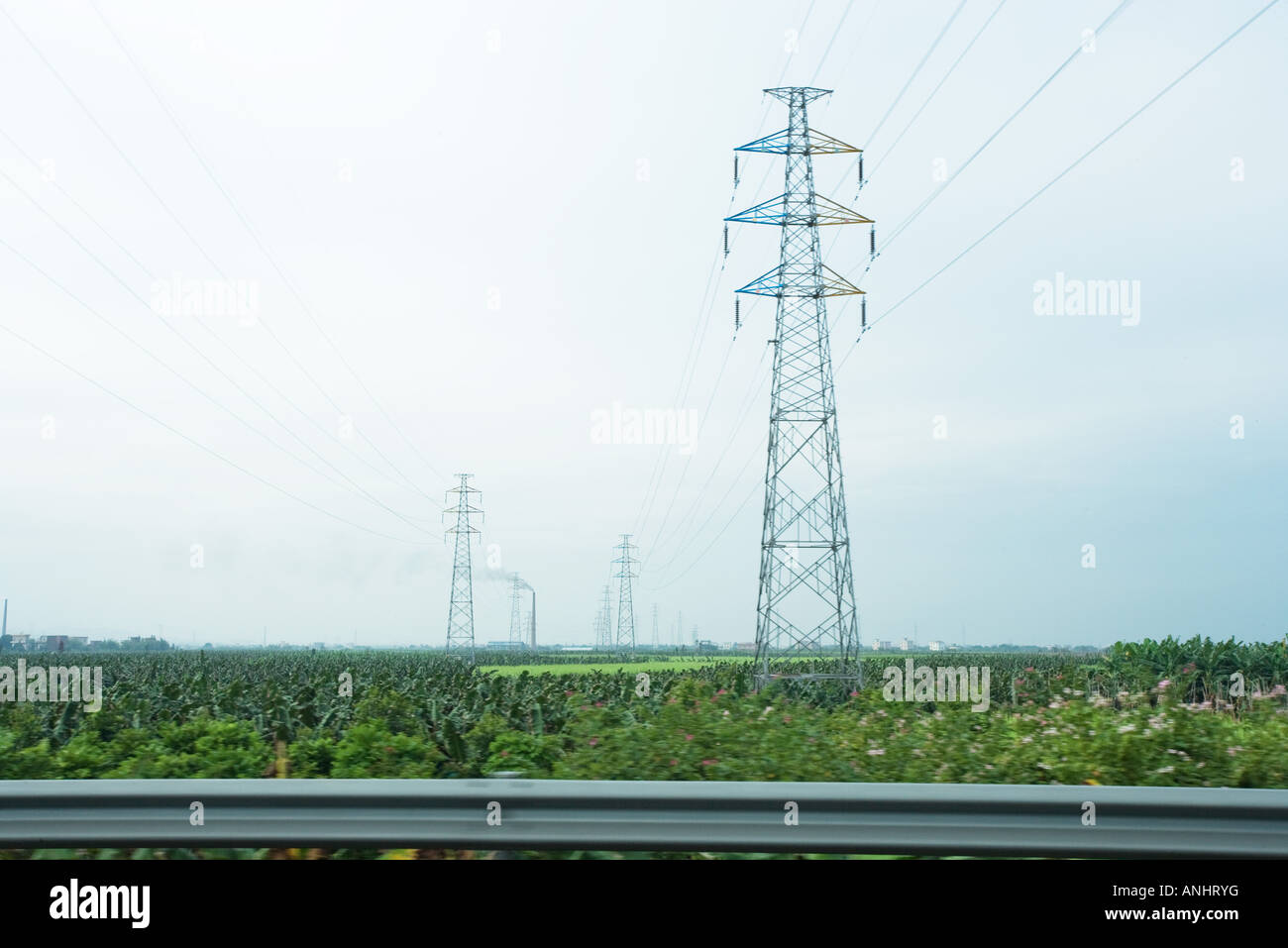 Electric pylons seen from highway Stock Photo - Alamy