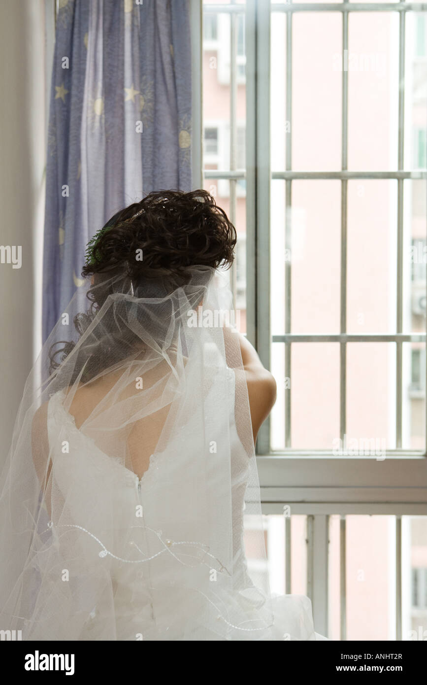 Bride facing window, rear view Stock Photo - Alamy