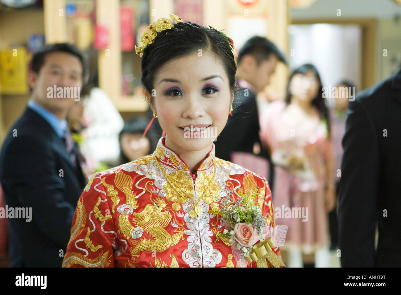 Bride dressed in traditional Chinese clothing, smiling at camera ...