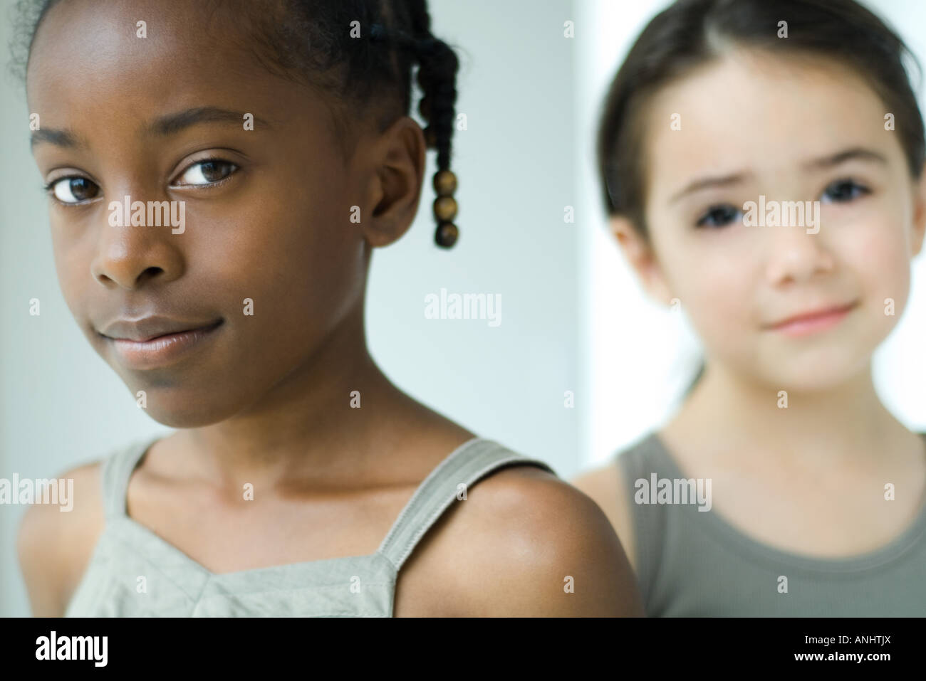 Two girls smiling at camera, focus on foreground Stock Photo - Alamy
