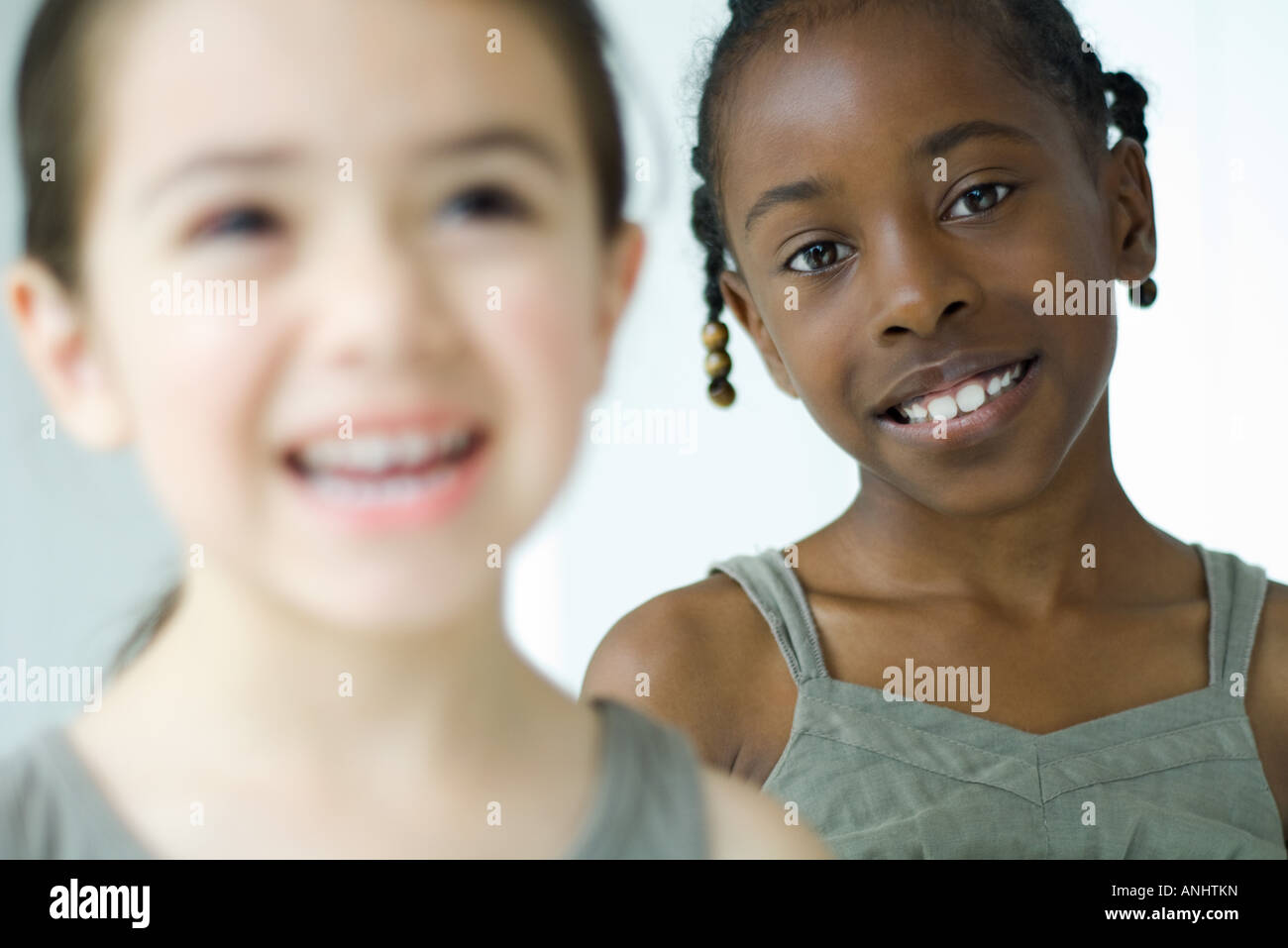 Two girls smiling, one looking at camera, selective focus Stock Photo ...