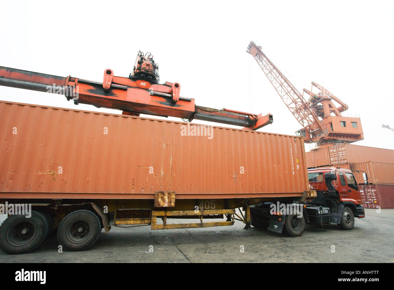 Cargo container being loaded onto truck Stock Photo - Alamy