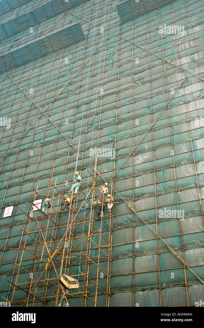 Building undergoing renovation, workers on scaffolding Stock Photo - Alamy