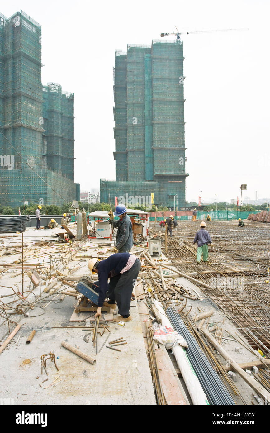 Construction workers working at construction site Stock Photo - Alamy
