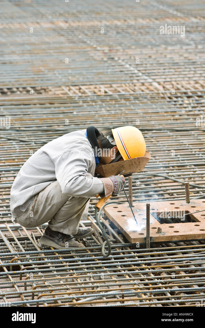 Construction worker working at construction site Stock Photo - Alamy